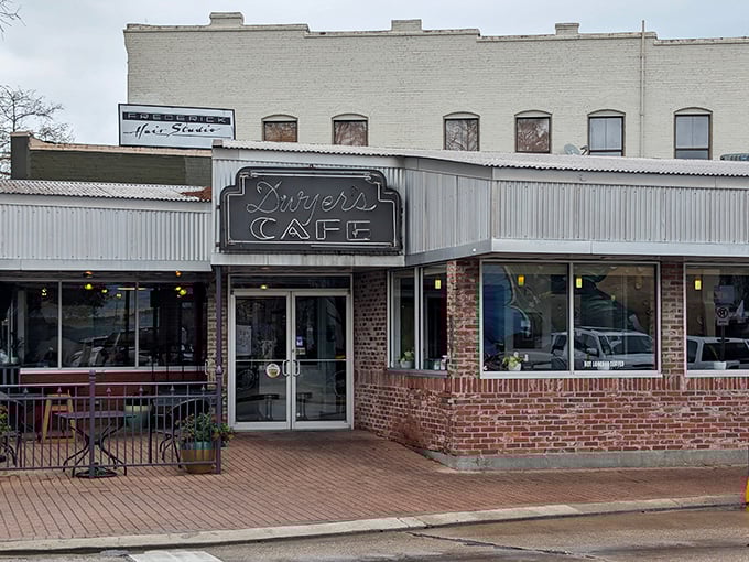 The iconic storefront of Dwyer's Cafe stands as a beacon of breakfast hope in downtown Lafayette, with its classic neon sign promising comfort inside.