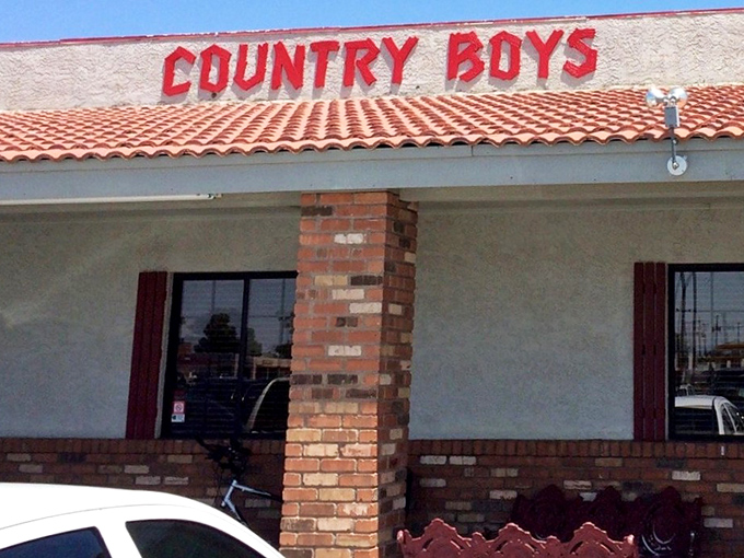 The iconic red lettering against the desert sky announces Country Boys like an old friend welcoming you home for a hearty meal.