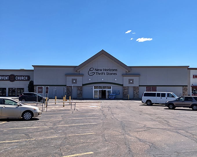 The unassuming exterior of New Horizons Thrift Store stands like a treasure chest waiting to be opened, promising adventures in secondhand shopping beneath Colorado's blue skies.