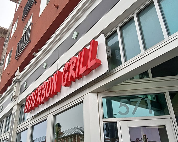 The bold red "BOURBON GRILL" sign beckons hungry passersby like a neon promise of flavor. No fancy frills needed when the food speaks this loudly.