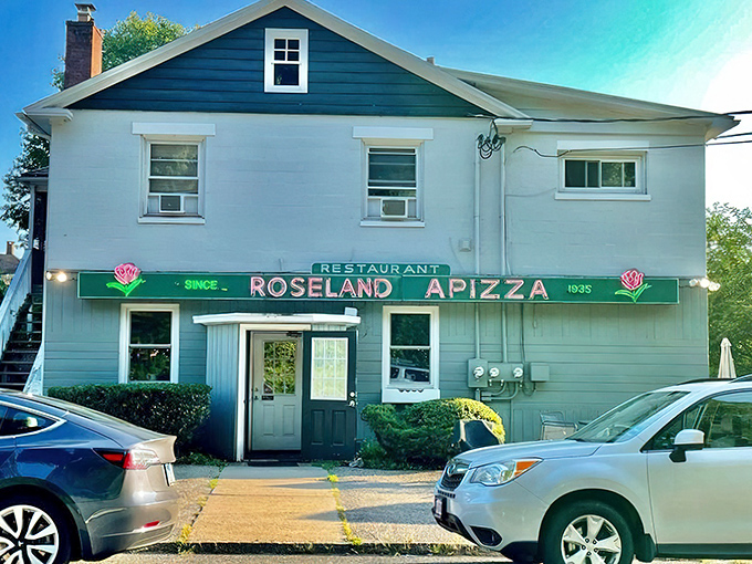The unassuming gray building with its vintage green sign has been luring pizza pilgrims for generations. Connecticut's best-kept secret hides in plain sight.