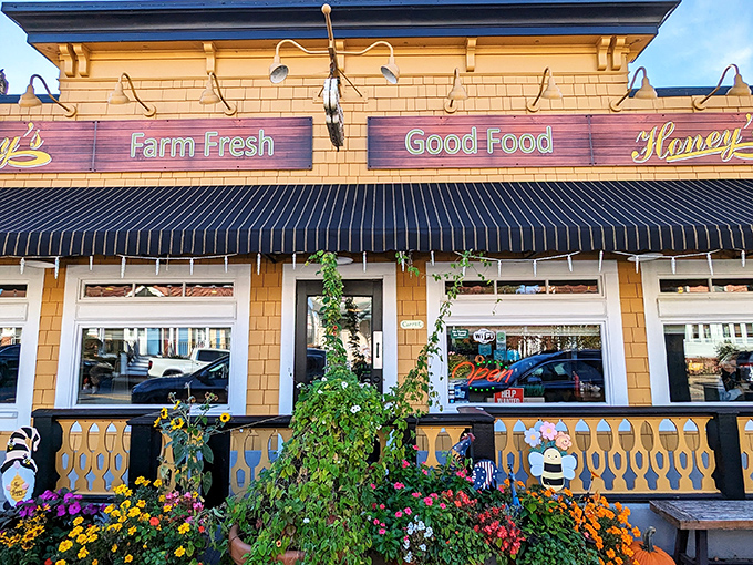 Summer blooms frame Honey's cheerful facade, creating the kind of curb appeal that makes you instinctively reach for your camera before your fork.