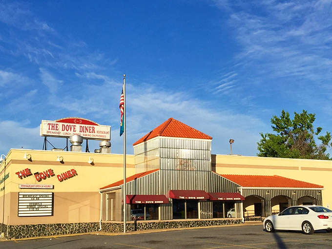 The Dove Diner's cream-colored exterior stands like a beacon of breakfast hope against Delaware's blue sky. American flag included, naturally.