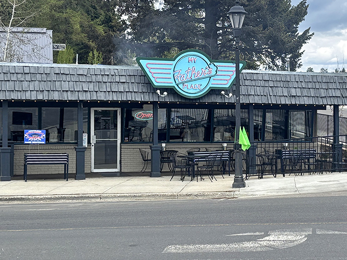 That neon-blue sign beckons like a lighthouse for the hungry. McCall's burger haven promises retro charm and modern flavors under one cedar-shingled roof.