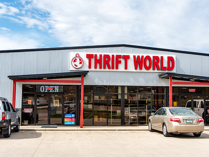 Thrift World's welcoming facade stands like a red-trimmed portal to bargain paradise&mdash;where your wallet stays fat and your shopping bags bulge with possibility.