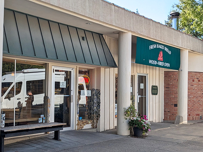 The unassuming exterior of Wheatfields Bakery Cafe, where that green awning might as well be saying "Carb Paradise Ahead!"