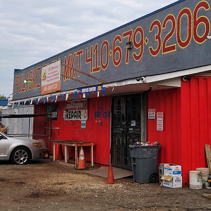 The iconic blue and red exterior of Pulaski Flea Market stands like a treasure chest waiting to be opened, promising adventures in bargain hunting within.