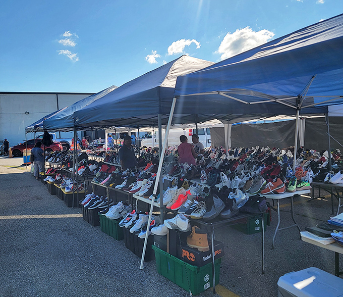 Sneaker heaven awaits! Tables overflow with footwear treasures where dedicated collectors hunt for that perfect pair while casual shoppers marvel at the sheer variety.