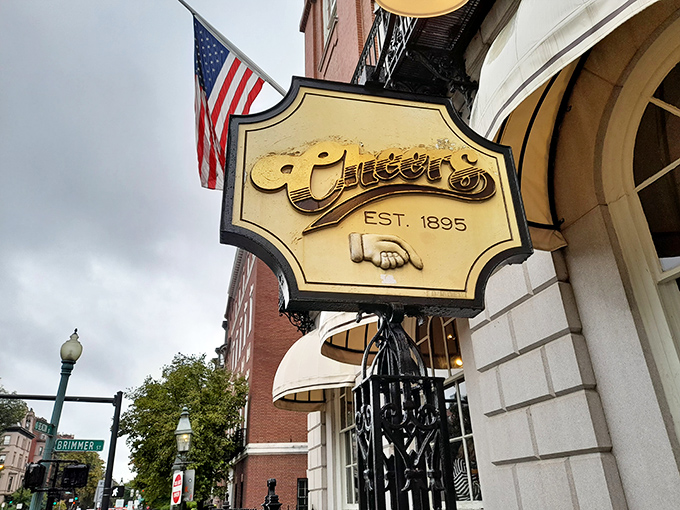 The iconic Cheers sign welcomes visitors to Boston's famous pub where exceptional root beer and nostalgia flow freely beneath Beacon Hill.