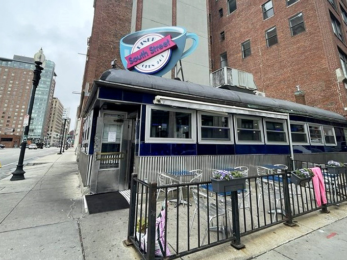 The iconic blue exterior and giant coffee cup sign of South Street Diner stands as a beacon in Boston's Leather District.