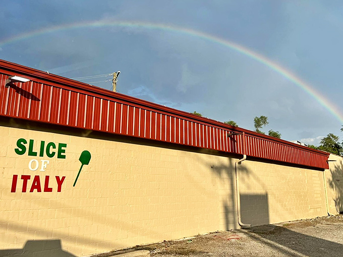 A rainbow arches over Slice of Italy like nature's own stamp of approval. Even the heavens can't resist this pizza paradise.
