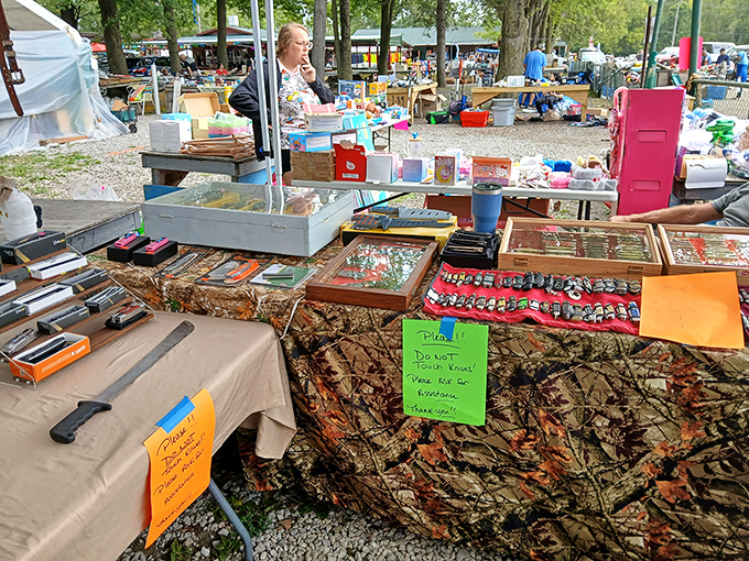 Treasure hunting in action! Tables overflow with collectibles while shoppers scan for that perfect find among the organized chaos of memories-for-sale.