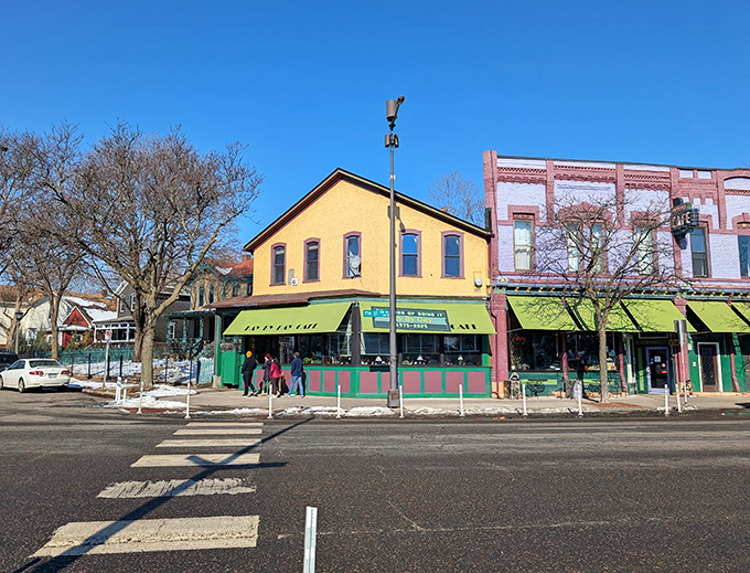 The bright yellow exterior with green awnings stands like a beacon of breakfast hope on this St. Paul corner, promising comfort food salvation within.