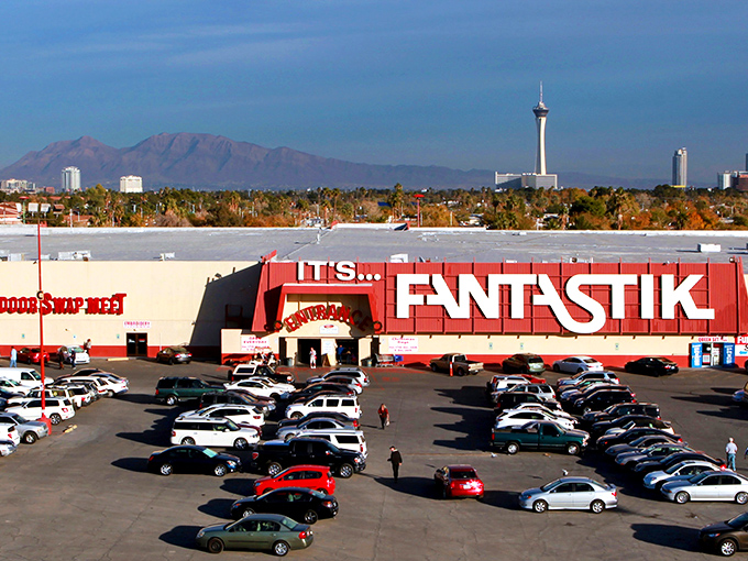The Fantastic Indoor Swap Meet stands proudly against the Las Vegas skyline, its bright red exterior promising treasures within like a desert mirage that actually delivers.