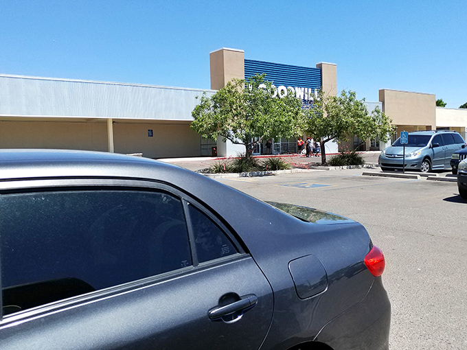Desert sunshine bathes this Albuquerque Goodwill, where smart shoppers pull up ready for the thrill of the hunt in a sea of asphalt possibility.