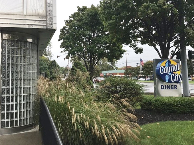 The classic exterior of Capital City Diner, with its vintage sign and gleaming chrome, looks like a time capsule you can actually eat in.