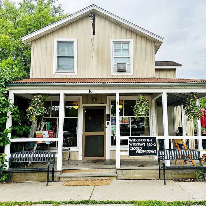 A welcoming front porch that practically whispers, "Come on in and stay awhile." Metal benches and potted flowers create the perfect prelude to the comfort food waiting inside.