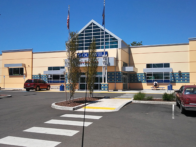 The distinctive triangular entrance of Milwaukie's Goodwill beckons bargain hunters like a retail lighthouse guiding ships to treasure-filled shores.