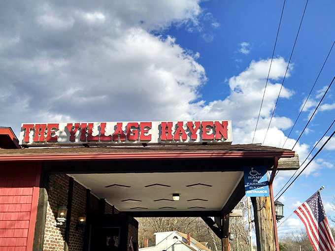 The iconic red exterior of The Village Haven stands proudly against the Rhode Island sky, a beacon of comfort food that's worth the journey.