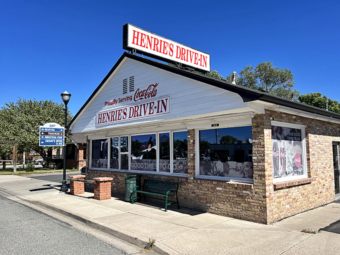 The classic brick exterior of Henrie's Drive In stands proudly against Utah's blue sky, a beacon for hungry travelers since long before Instagram food pics.