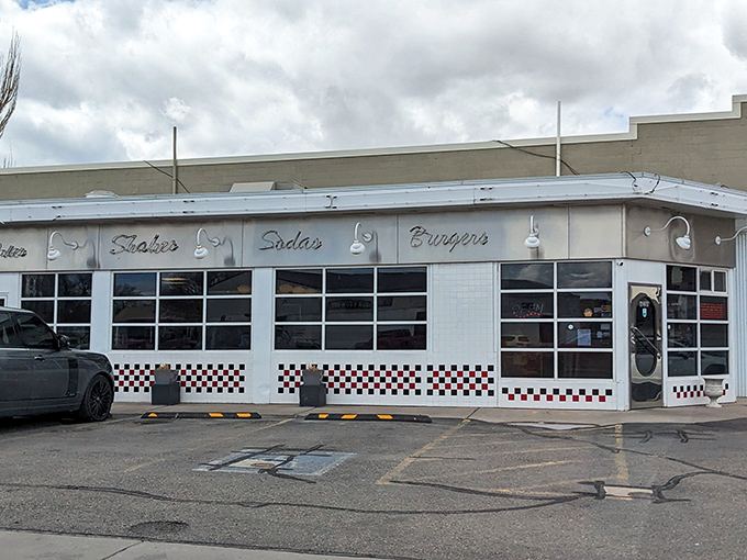 The classic white exterior with "Shakes, Sodas, Burgers" signage promises a time-traveling culinary adventure in Rock Springs.