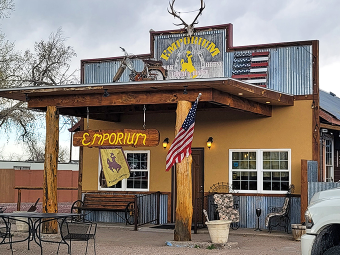 The Emporium's welcoming facade features rustic Wyoming charm with antlers, corrugated metal, and proudly displayed American and bucking bronco flags.