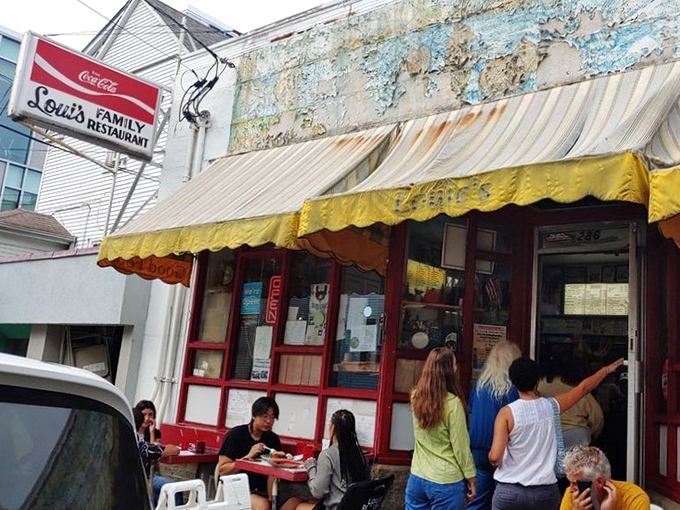 The yellow awning and vintage Coca-Cola sign aren't trying to impress anyone&mdash;they're too busy promising authentic diner magic within those weathered walls.