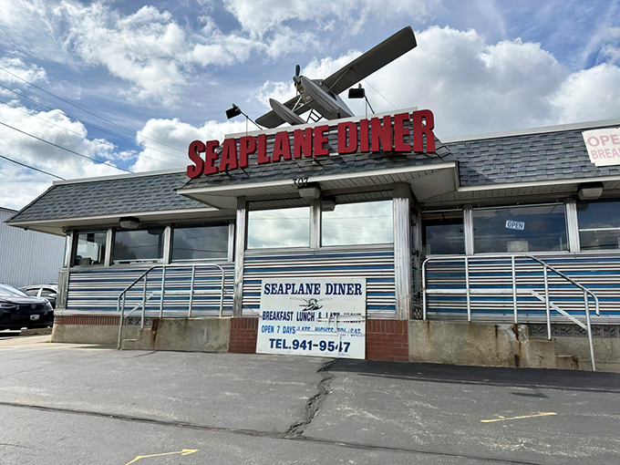 The iconic Seaplane Diner stands proudly against the Rhode Island sky, its vintage aircraft model announcing "good food ahead!"