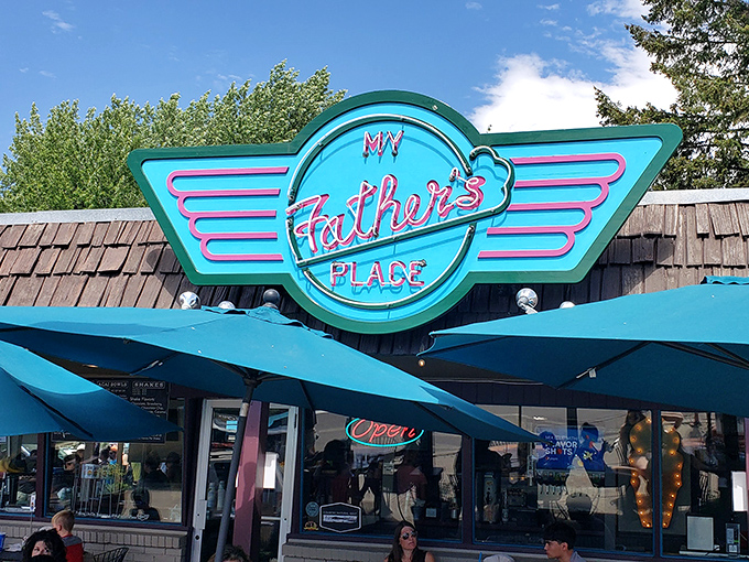 The iconic neon sign beckons hungry travelers like a burger lighthouse on McCall's shore. Resistance is futile.