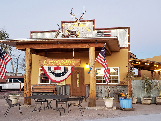 The Emporium's welcoming facade features rustic Wyoming charm with antlers, corrugated metal, and proudly displayed American and bucking bronco flags.