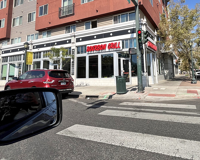 The bold red "BOURBON GRILL" sign beckons hungry passersby like a neon promise of flavor. No fancy frills needed when the food speaks this loudly.
