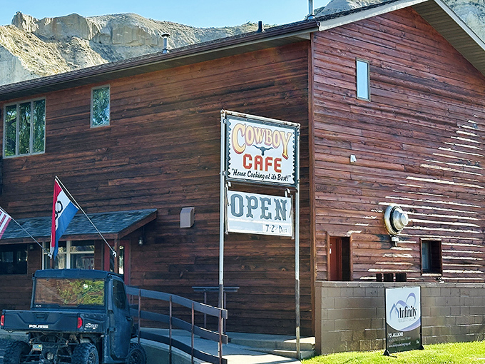 The Cowboy Cafe stands like a wooden sentinel against Medora's dramatic badlands, promising hearty meals and authentic western hospitality to weary travelers.