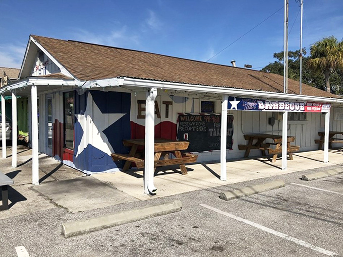 Texas pride meets Florida sunshine at this unassuming BBQ haven. The iconic Lone Star painted on the exterior promises authentic smoky treasures within.