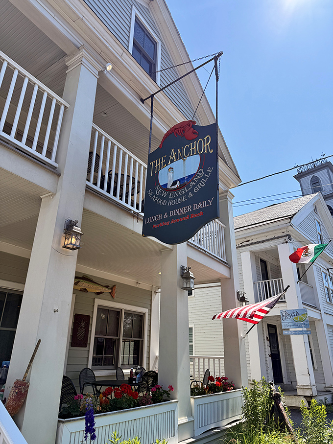The Anchor's classic New England facade welcomes seafood lovers with its charming porch, hanging lobster sign, and promise of maritime delights in Vermont's mountain landscape.