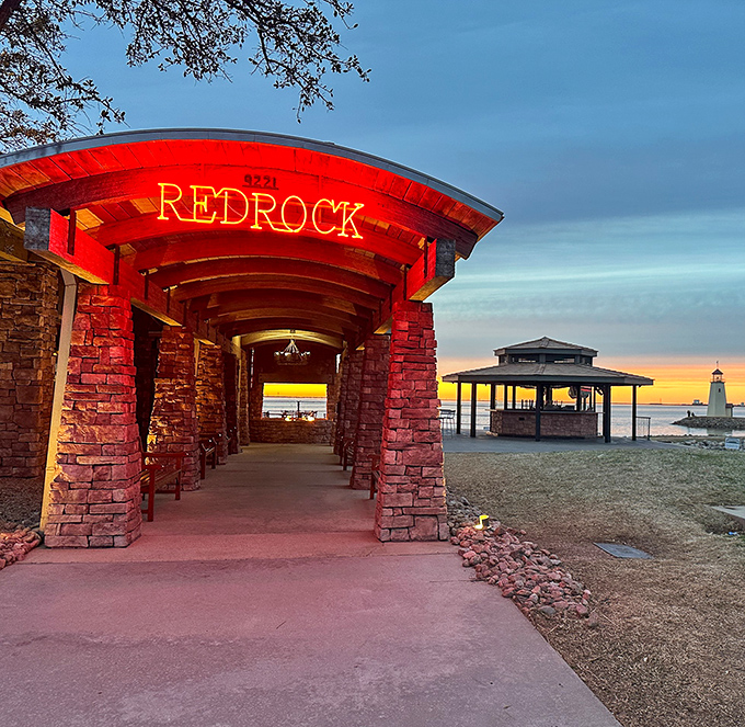 The iconic red glow of Redrock's entrance beckons like a desert mirage at sunset, promising culinary adventures ahead.