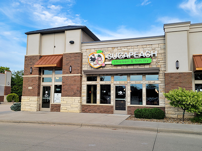 Sugapeach's unassuming exterior hides culinary treasures within, like finding a diamond in a strip mall. The bright logo promises Southern comfort in the heart of Iowa.