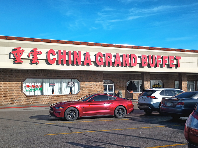 The bold red signage of China Grand Buffet beckons hungry Idahoans like a culinary lighthouse in a sea of strip mall sameness.