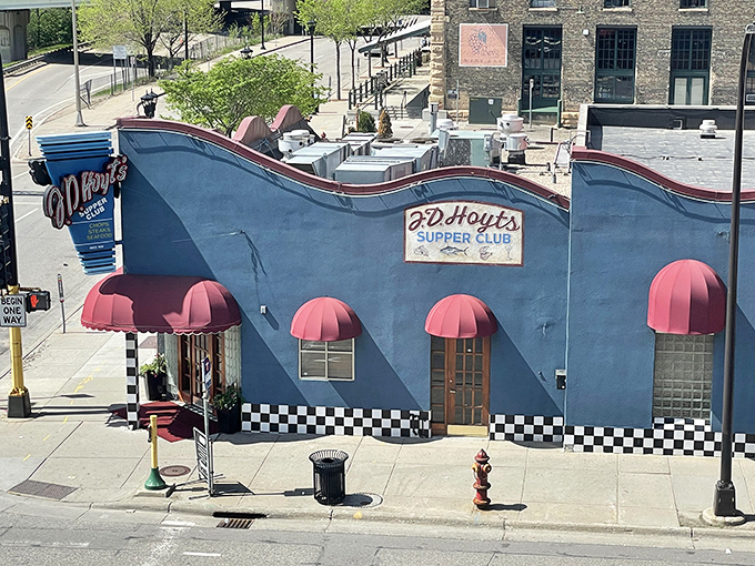 That wavy blue exterior with cherry-red awnings isn't just eye-catching&mdash;it's a beacon for carnivores seeking refuge from ordinary dining experiences.
