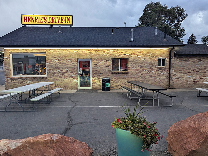 The brick exterior of Henrie's glows at dusk, a beacon of burger bliss in Panguitch. Those red rocks aren't just decoration&mdash;they're Utah's way of setting the table.