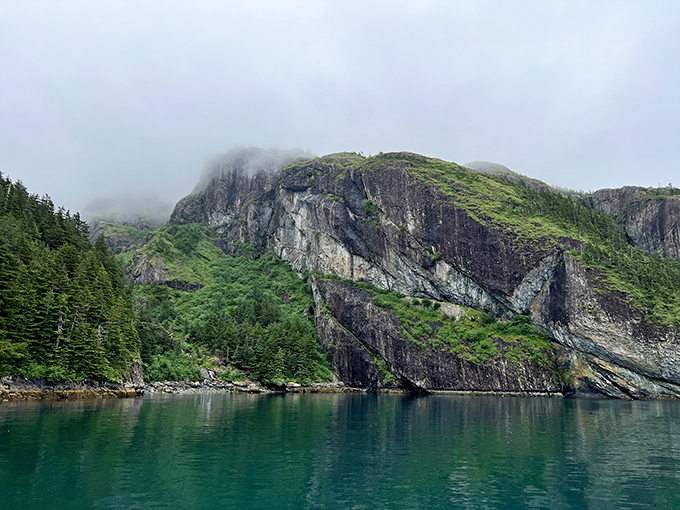 Misty mountains meet turquoise waters in this fjord landscape that makes your average screen saver look like amateur hour.