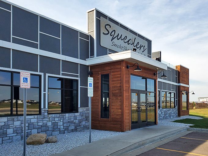 Modern meets rustic at Squealer's exterior, where the wood-accented entrance promises smoky treasures within. No fancy gimmicks needed when the food does the talking.