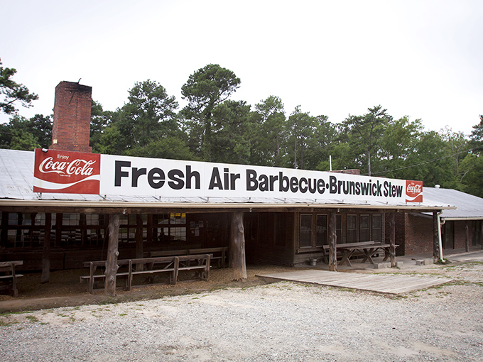 The barbecue promised land reveals itself with a humble facade, brick chimney standing sentinel over decades of smoke-infused tradition.