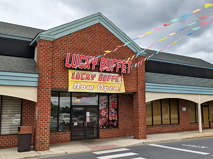 The brick facade might say "strip mall," but that glowing red sign promises culinary adventures that'll have you planning your next visit before you've finished the first plate.