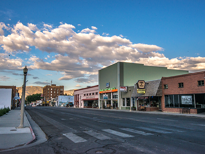Sunset bathes Ely's charming downtown in golden light, transforming humble brick buildings into a Norman Rockwell painting where your dollar stretches further than the spectacular Nevada sky above.