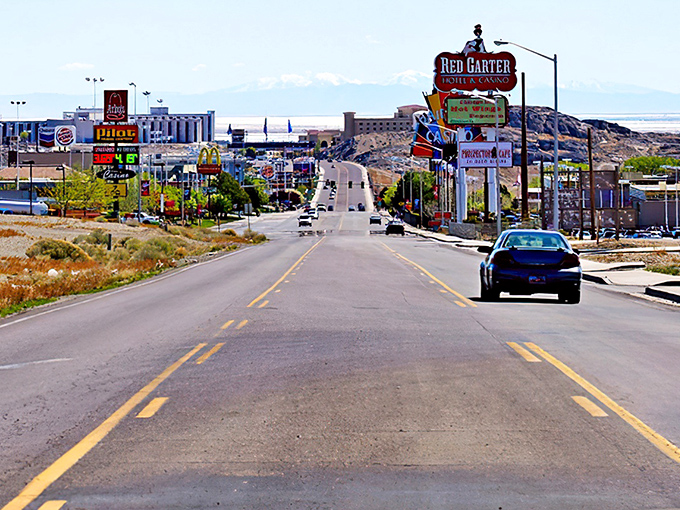 The iconic Red Garter sign welcomes you to West Wendover, where the desert road stretches toward affordable adventure and mountain-framed possibilities.