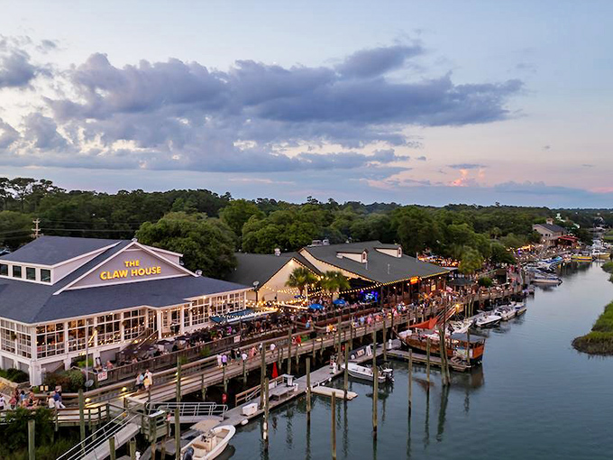 The MarshWalk comes alive as golden hour approaches, transforming this waterfront boardwalk into pure coastal magic.