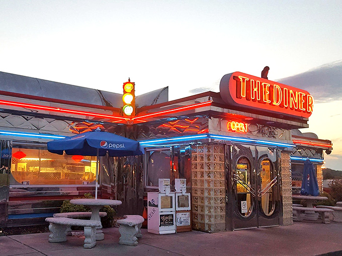 The neon glow of THE DINER at dusk isn't just a sign&mdash;it's a promise of comfort food nirvana waiting just beyond those glass-block walls.