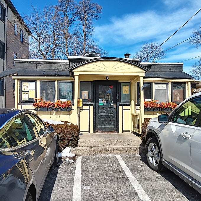Casey's Diner stands proudly in Natick, its cheerful yellow exterior and curved roof a beacon for hungry travelers seeking authentic New England comfort food.