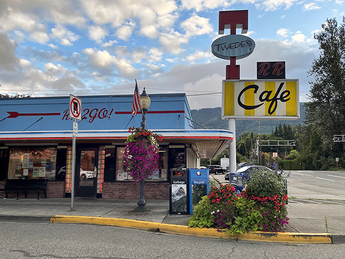 That classic neon sign beckons like an old friend against the Washington sky, promising comfort food and a slice of small-town Americana.