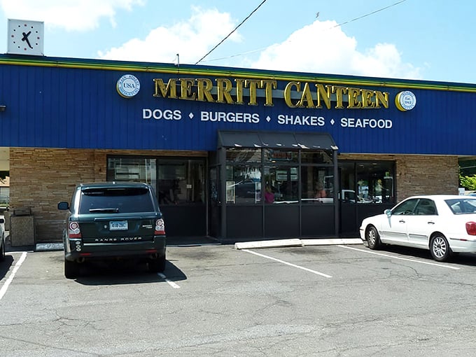 The iconic blue exterior of Merritt Canteen welcomes hungry visitors with its straightforward promise of dogs, burgers, shakes, and seafood.